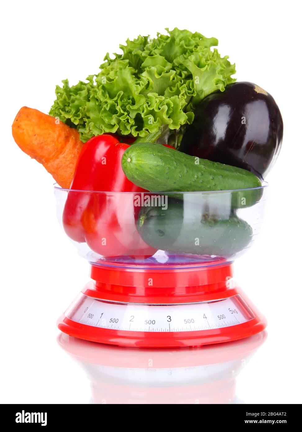 Fresh vegetables in scales isolated on white Stock Photo - Alamy