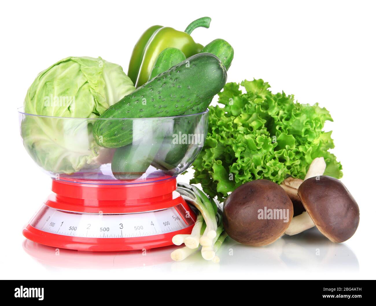 Fresh vegetables in scales isolated on white Stock Photo - Alamy