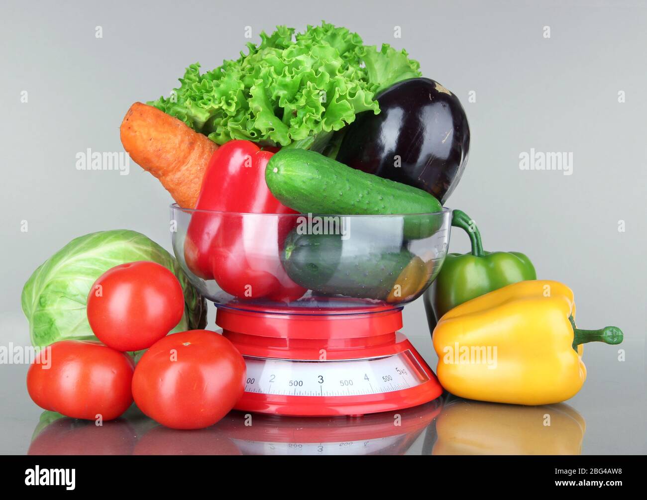 Fresh vegetables in scales on gray background Stock Photo - Alamy