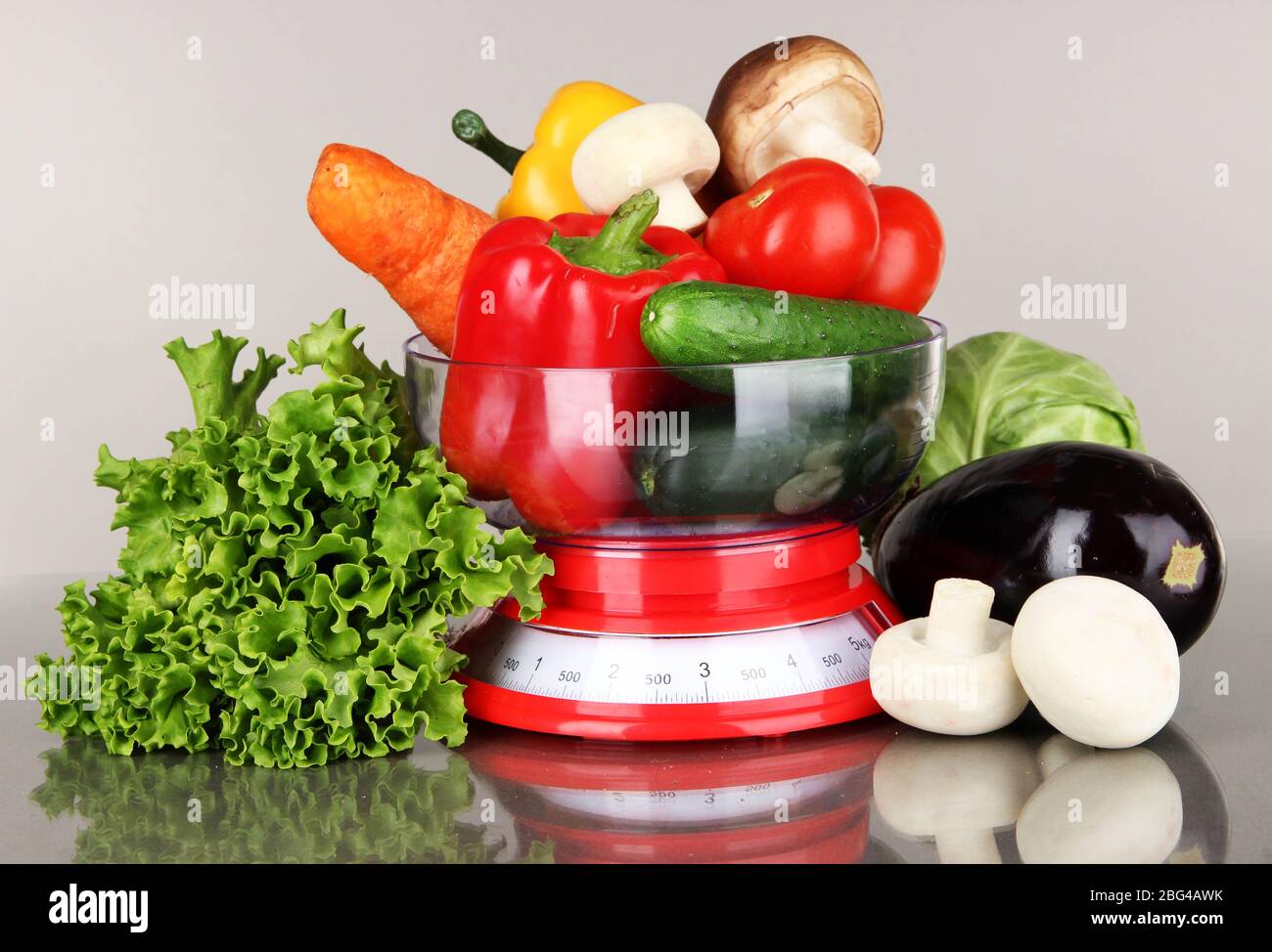 Fresh vegetables in scales on gray background Stock Photo - Alamy