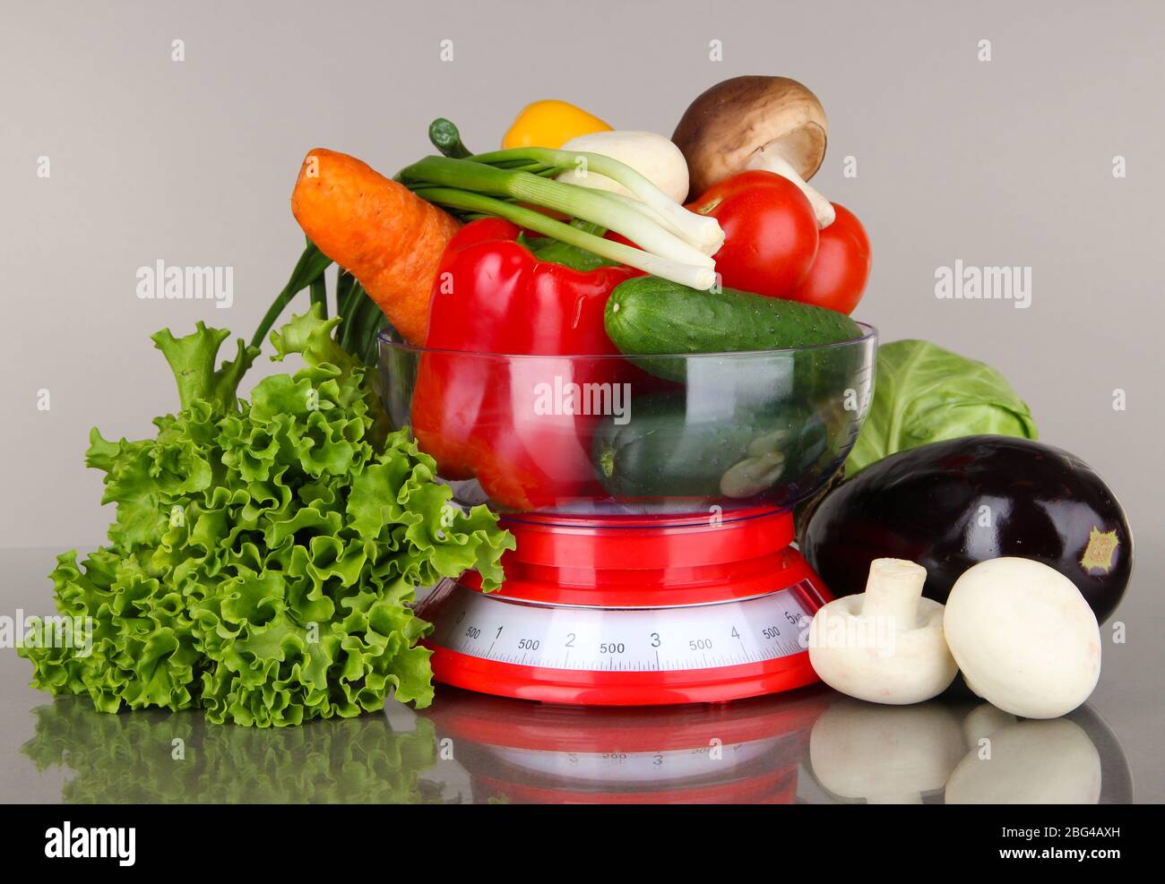 Fresh vegetables in scales on gray background Stock Photo - Alamy