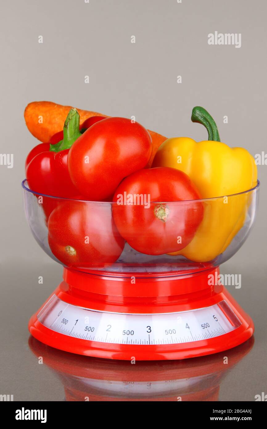 Fresh vegetables in scales on gray background Stock Photo - Alamy