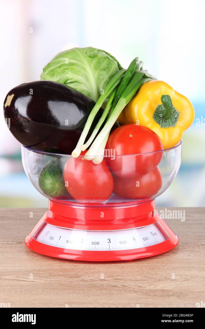 Fresh vegetables in scales on table in kitchen Stock Photo - Alamy
