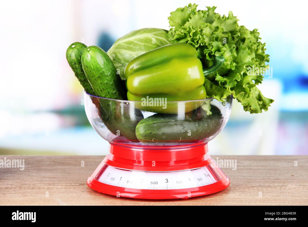 Fresh vegetables in scales on table in kitchen Stock Photo - Alamy
