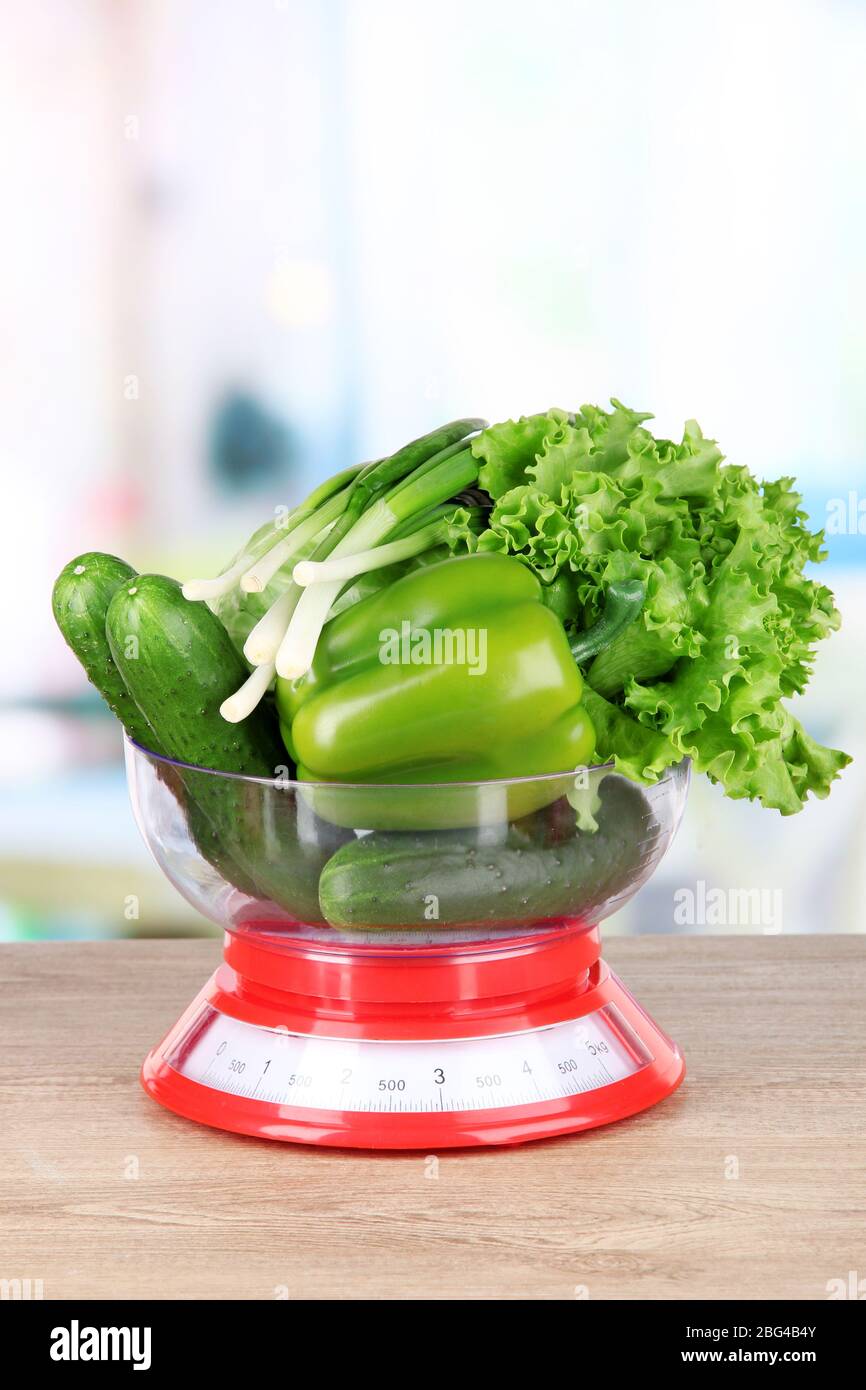 Fresh vegetables in scales on table in kitchen Stock Photo - Alamy