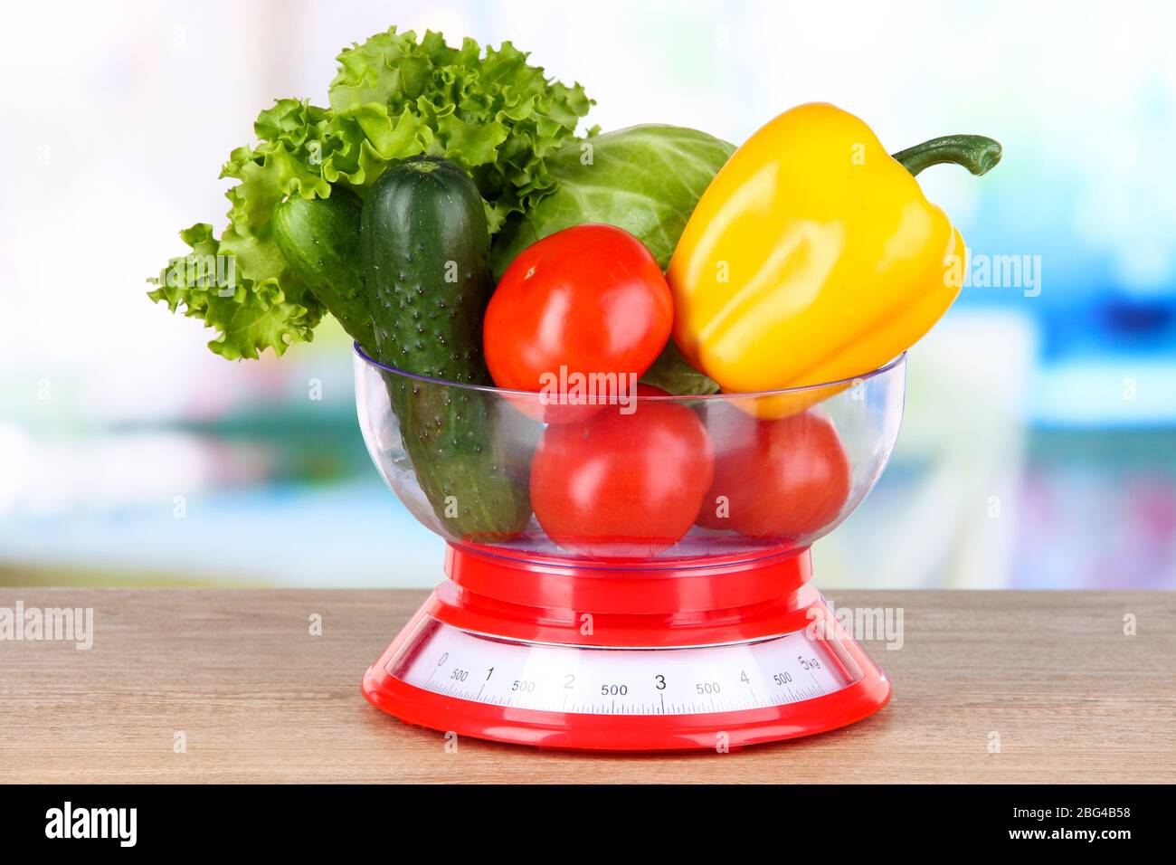 Fresh vegetables in scales on table in kitchen Stock Photo - Alamy