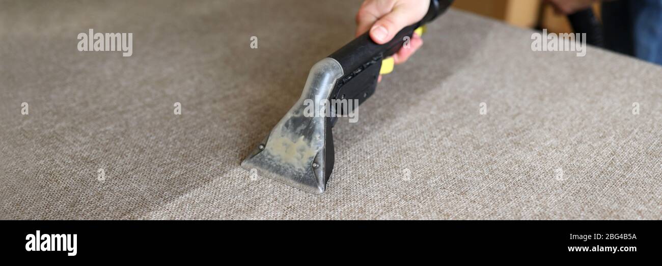 Male housekeeper arm cleaning sofa with washing vacuum cleaner Stock ...
