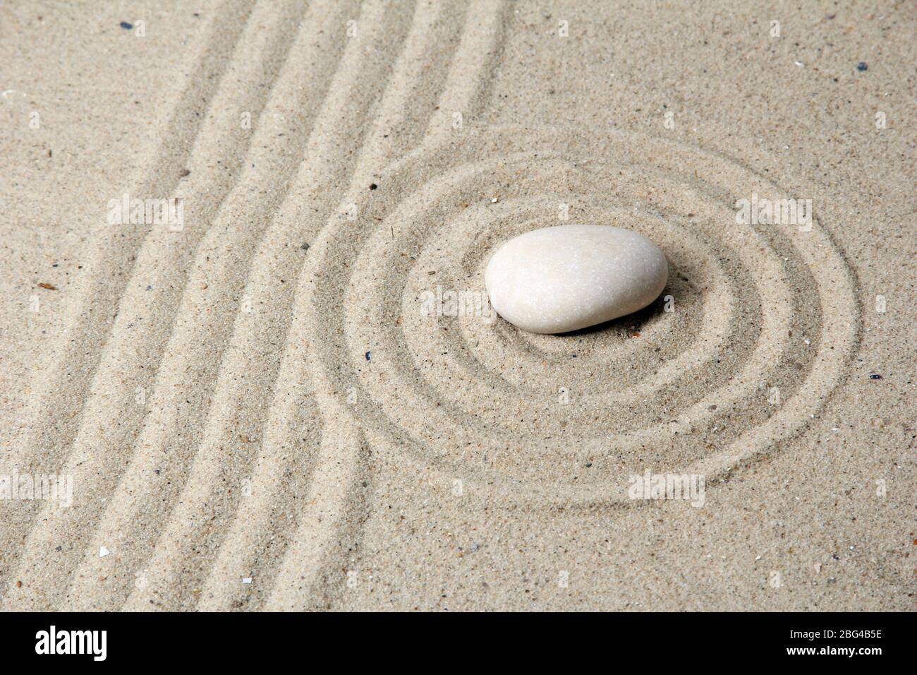 Zen garden with raked sand and round stone close up Stock Photo - Alamy