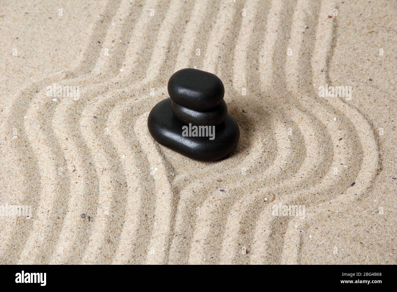 Zen garden with raked sand and round stones close up Stock Photo - Alamy