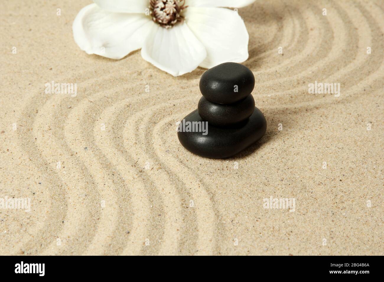 Zen garden with raked sand and round stones close up Stock Photo - Alamy