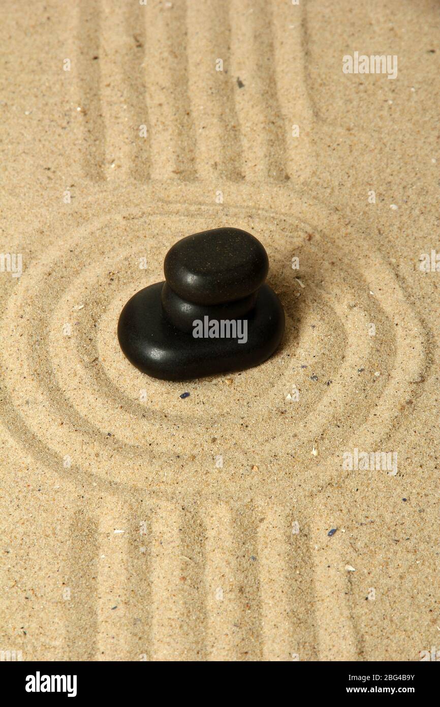 Zen garden with raked sand and round stones close up Stock Photo - Alamy