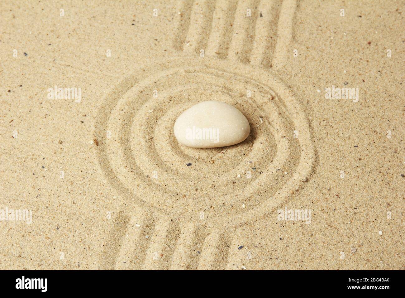 Zen garden with raked sand and round stone close up Stock Photo - Alamy