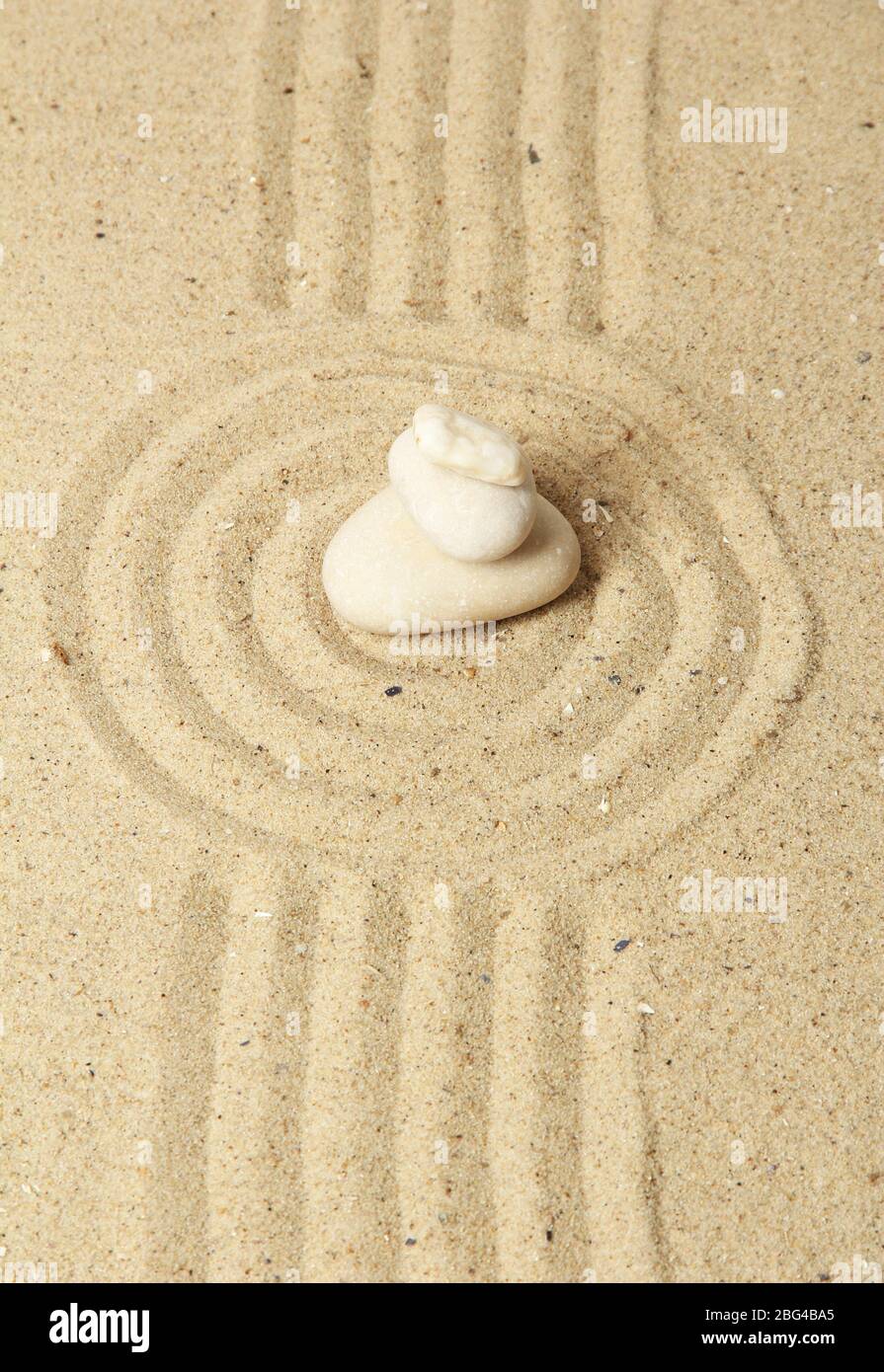 Zen garden with raked sand and round stones close up Stock Photo - Alamy