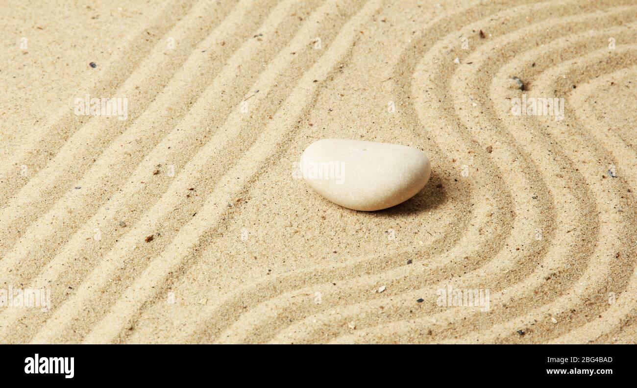 Zen garden with raked sand and round stones close up Stock Photo - Alamy