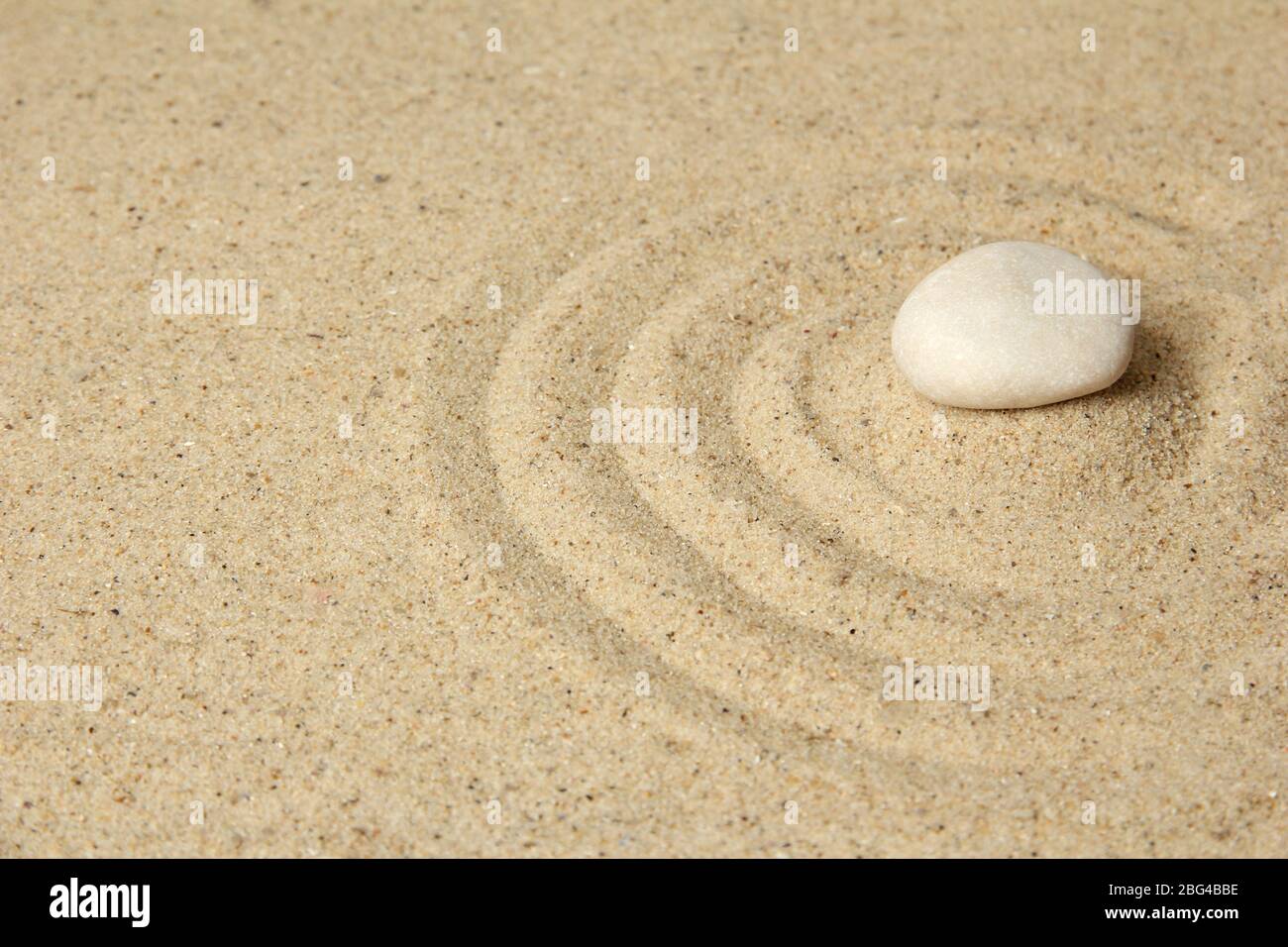 Zen garden with raked sand and stone close up Stock Photo - Alamy