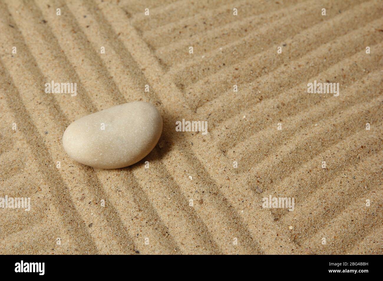 Zen garden with raked sand and round stone close up Stock Photo - Alamy