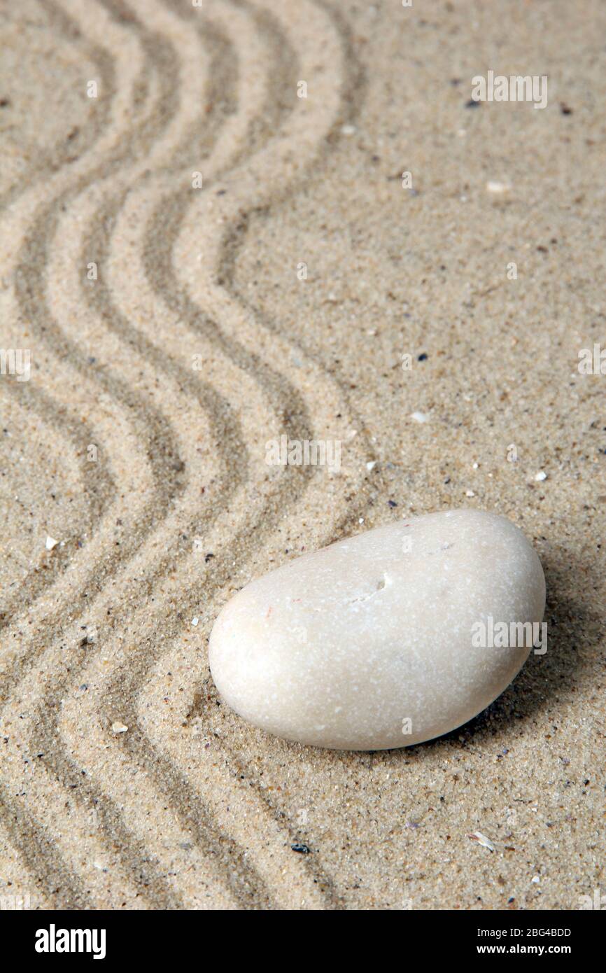Zen garden with raked sand and stone close up Stock Photo - Alamy