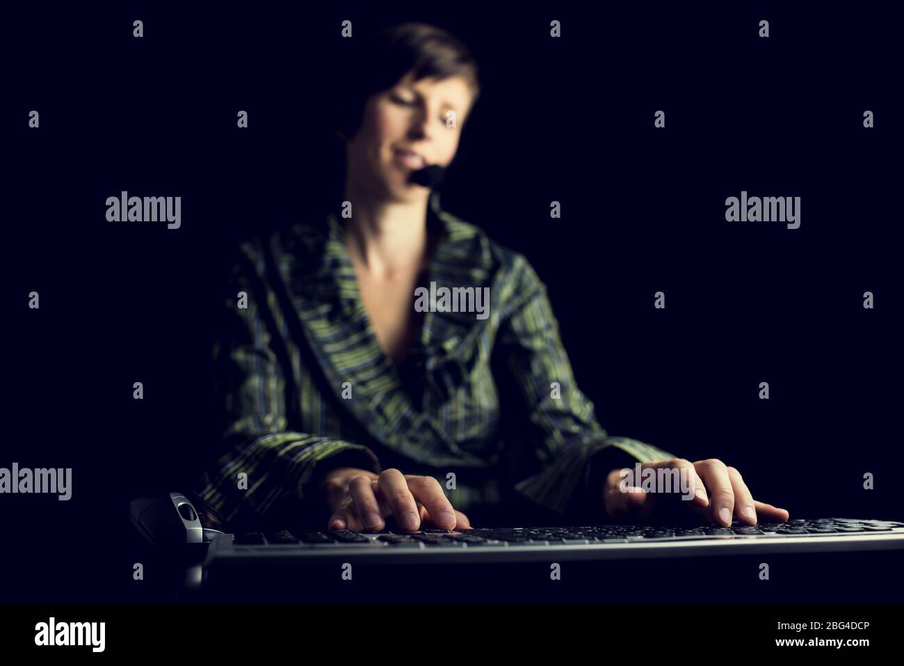 Retro image of young female customer service operator typing on ...