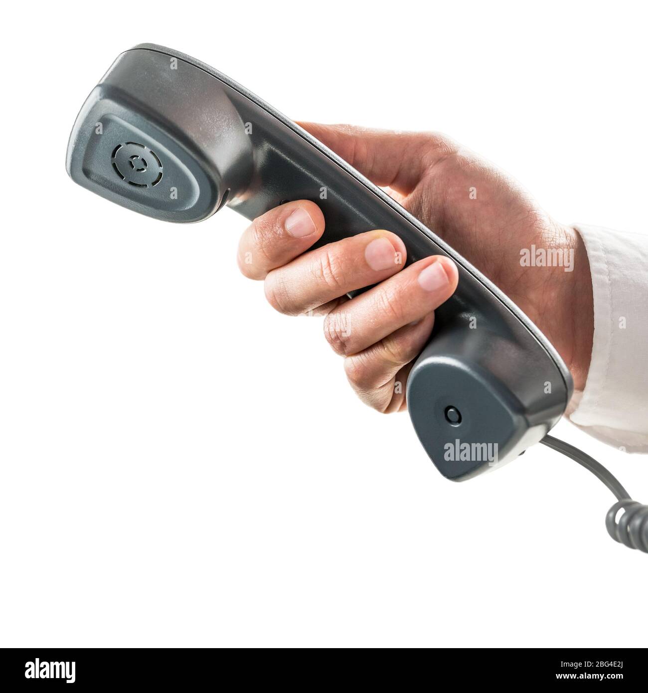 Male hand holding an old-fashioned black telephone receiver handset in ...