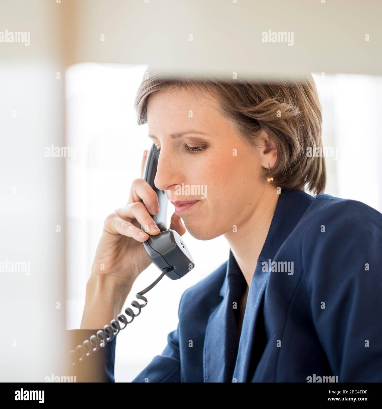 View through an internal office partition of a successful young ...