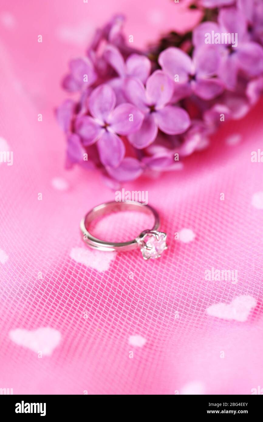 Beautiful wedding ring on pink background Stock Photo - Alamy