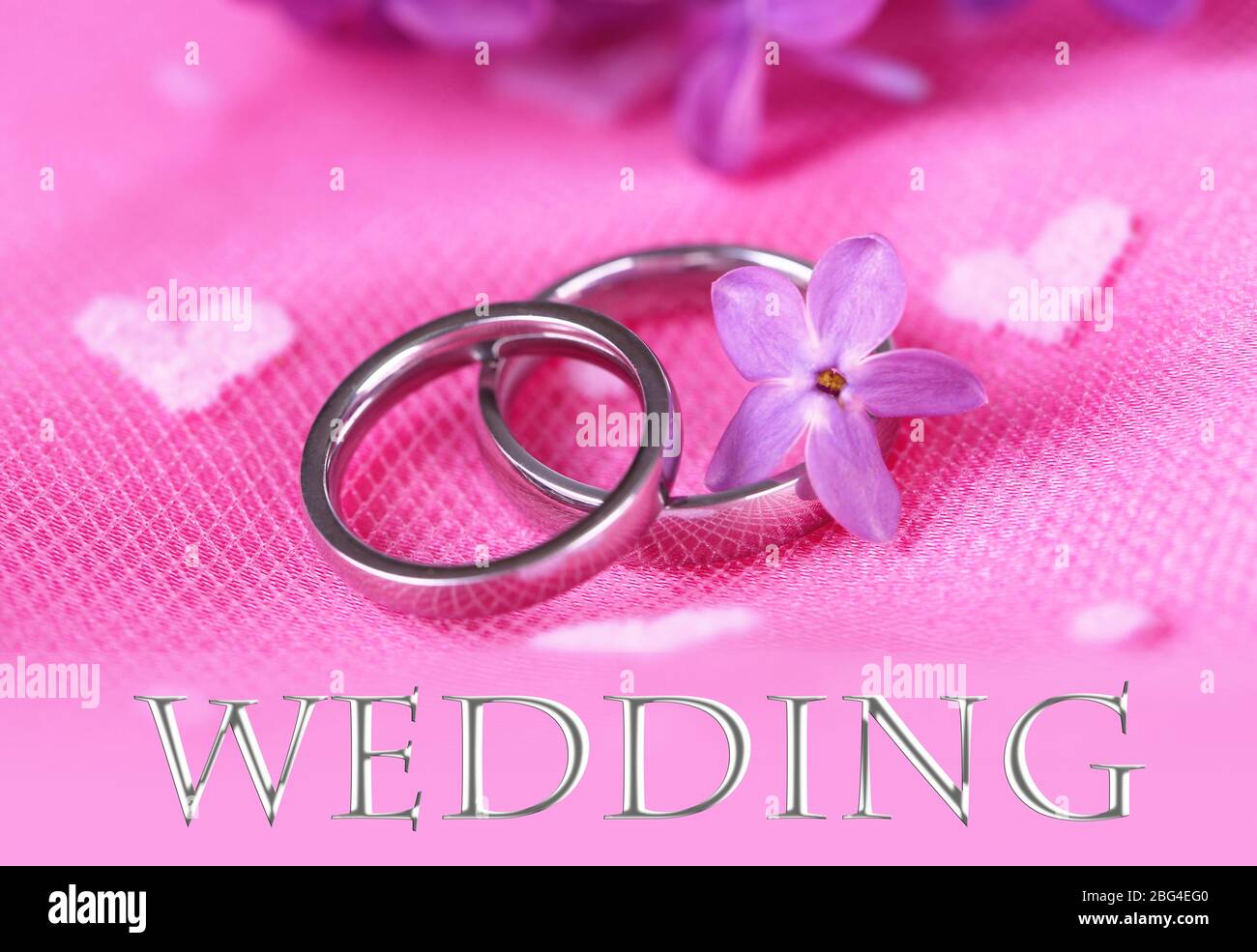 Beautiful wedding rings on pink background Stock Photo - Alamy