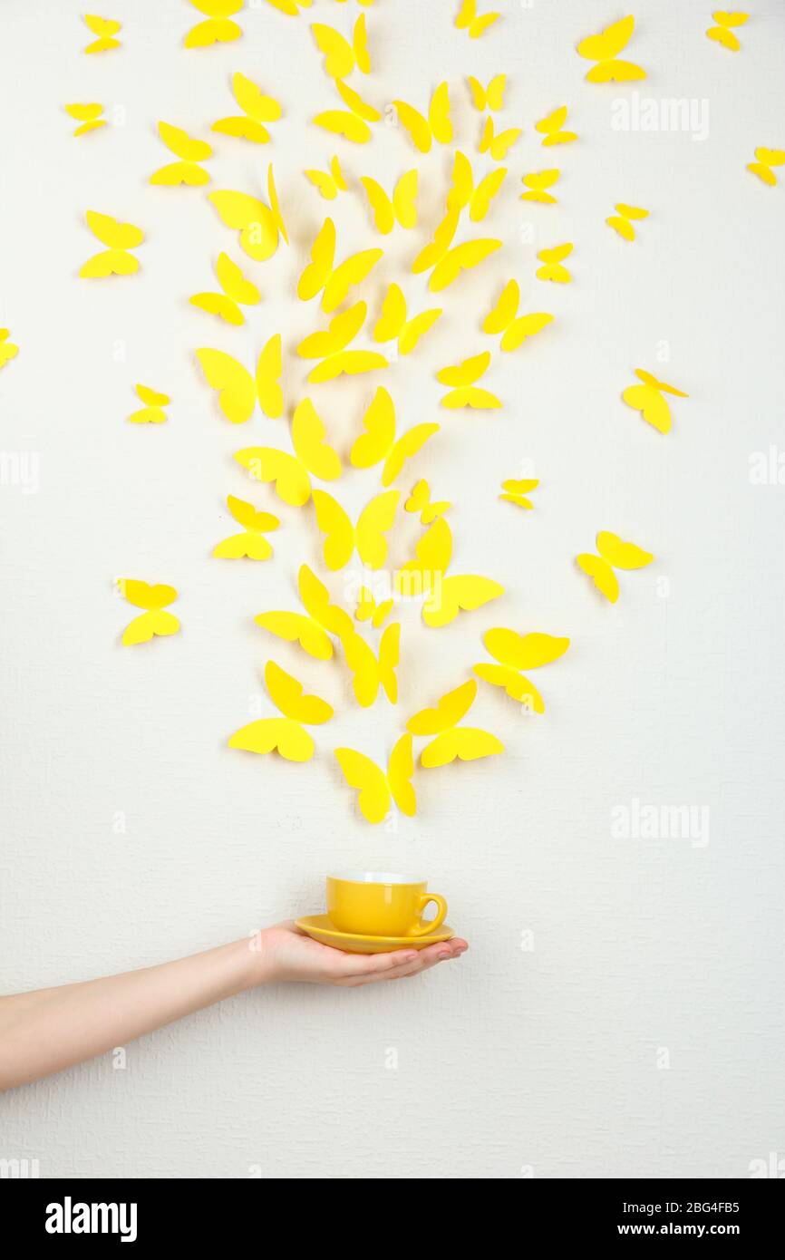 Paper yellow butterflies fly out of cup Stock Photo - Alamy