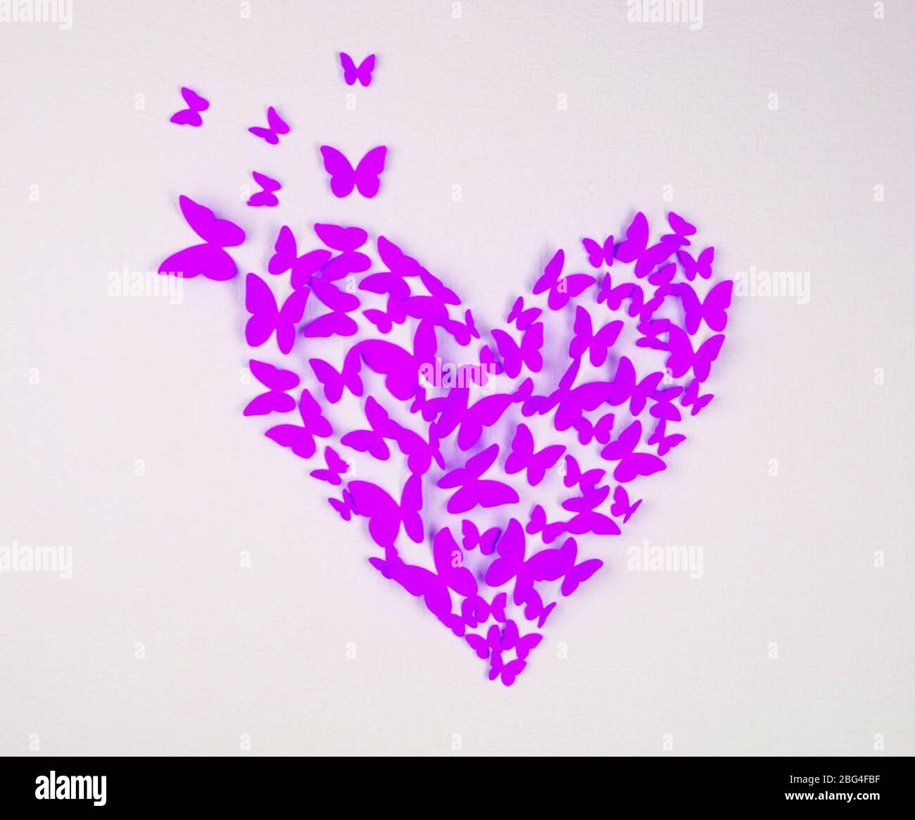 Paper purple butterfly in form of heart on wall Stock Photo - Alamy