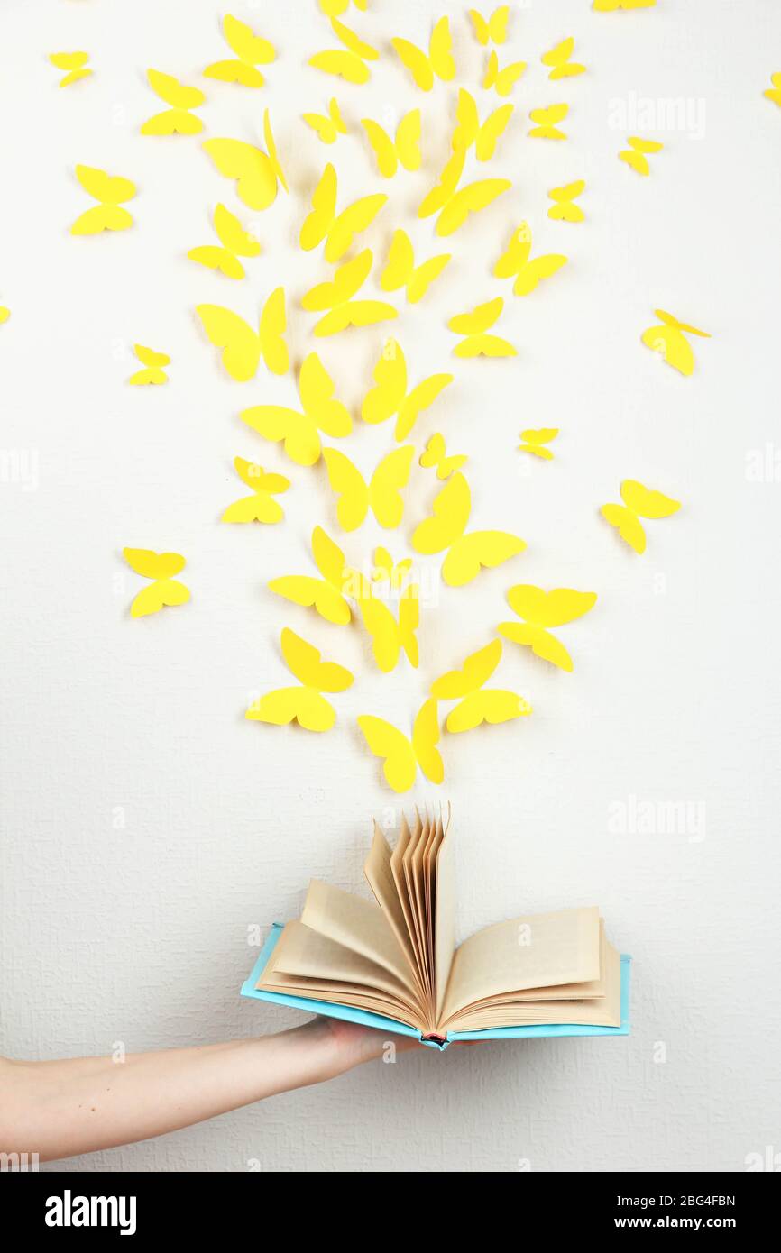 Paper yellow butterflies fly out of book Stock Photo - Alamy