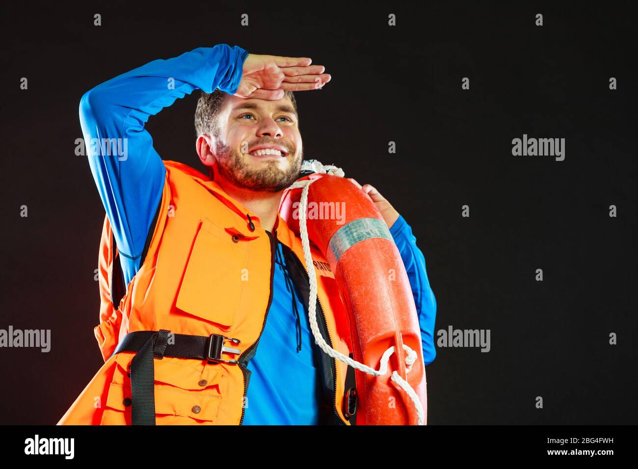 Lifeguard man in life vest jacket with ring buoy lifebuoy supervising ...