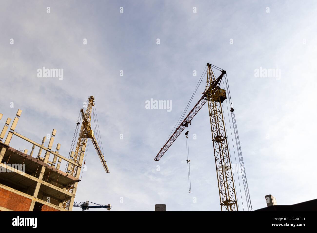 Boom cranes on a background of cloudy cloudy sky and building Stock ...