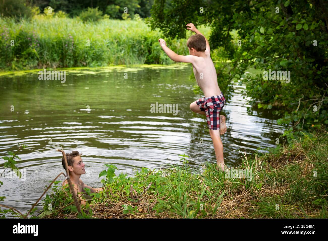boy jumping into a river Stock Photo - Alamy