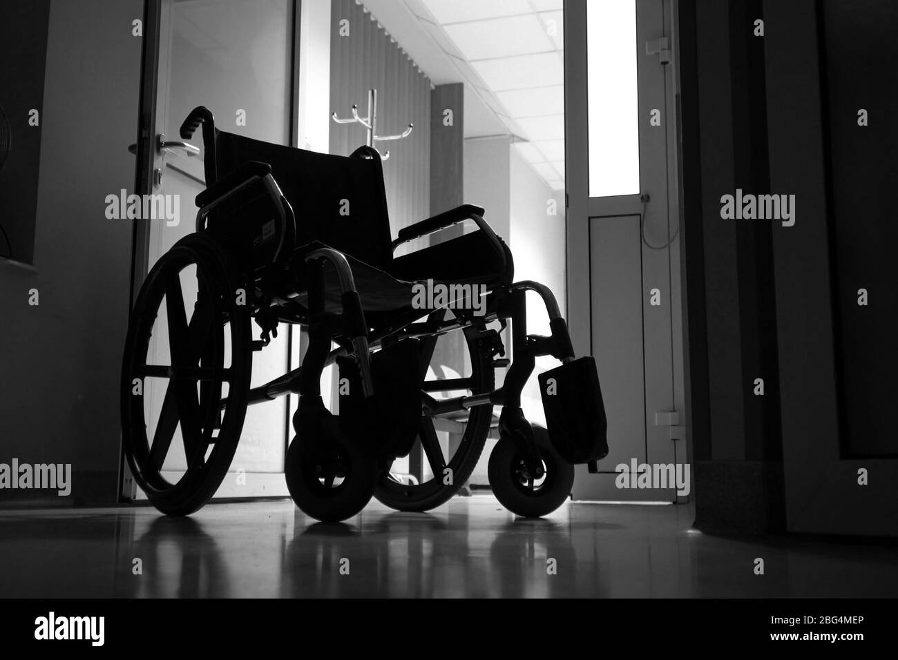 Empty wheelchair parked in hospital hallway Stock Photo - Alamy