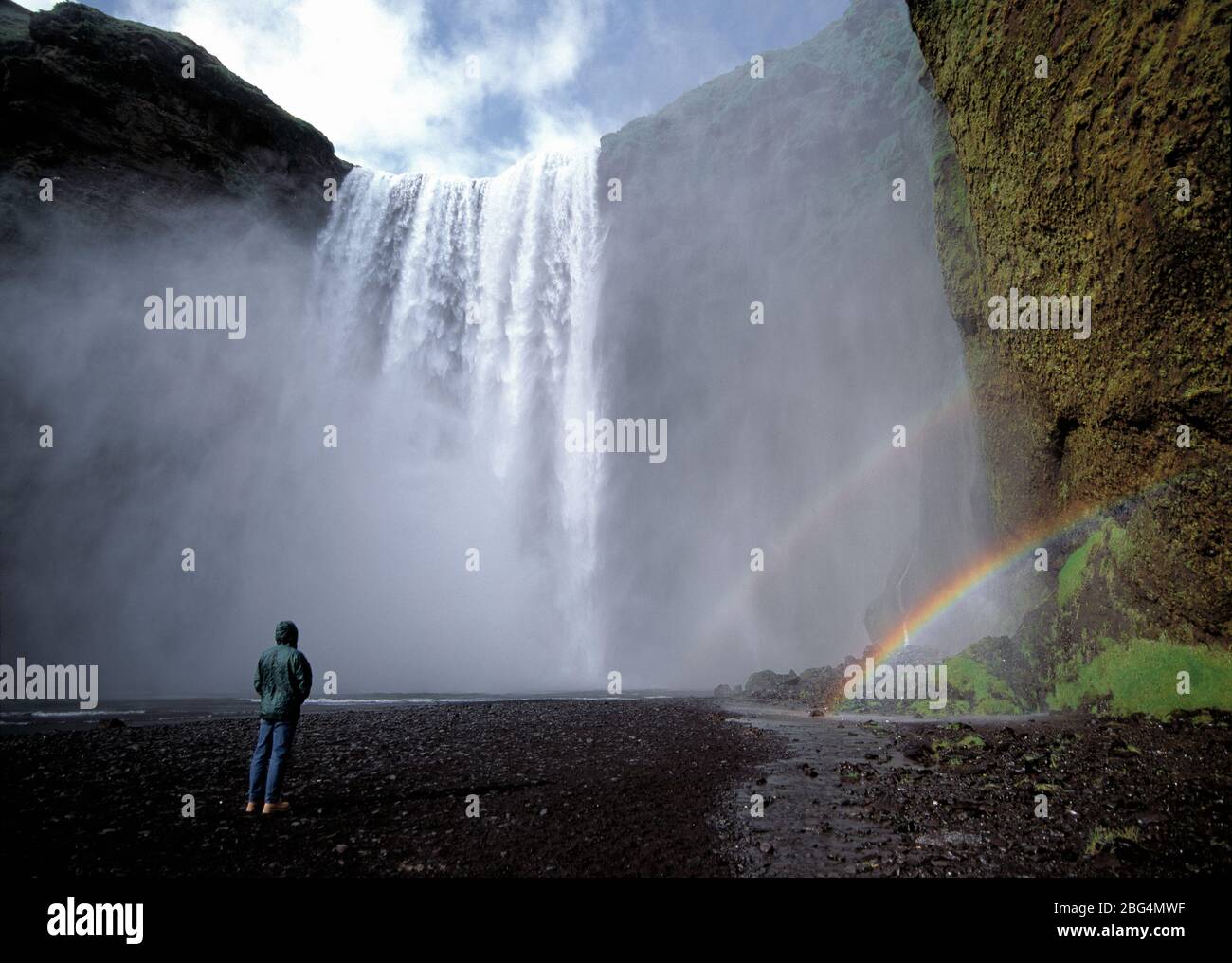 Person standing in front of waterfall hi-res stock photography and ...