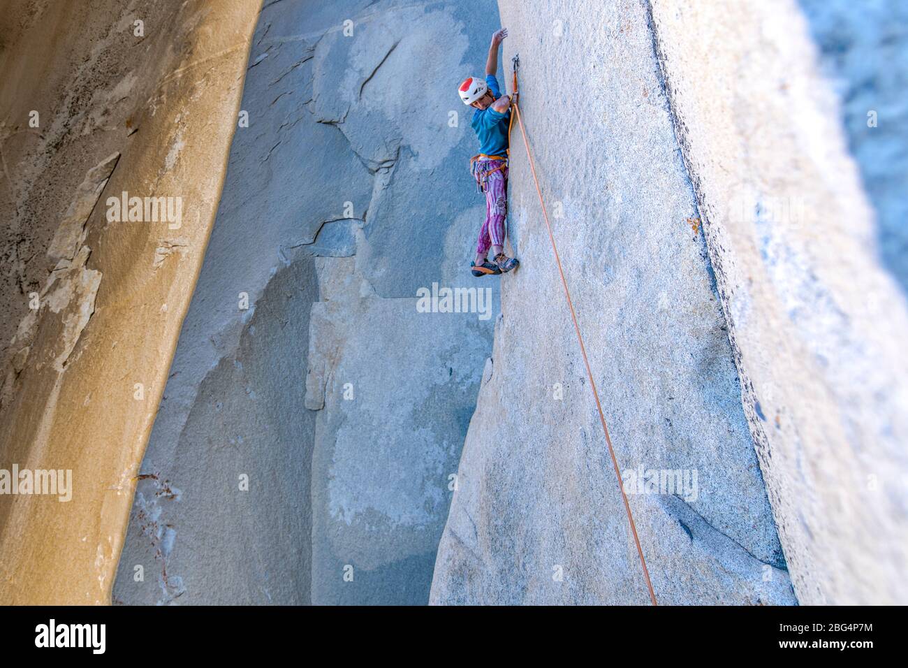 Rock climber looking down while climbing on big wall in Yosemite Stock ...