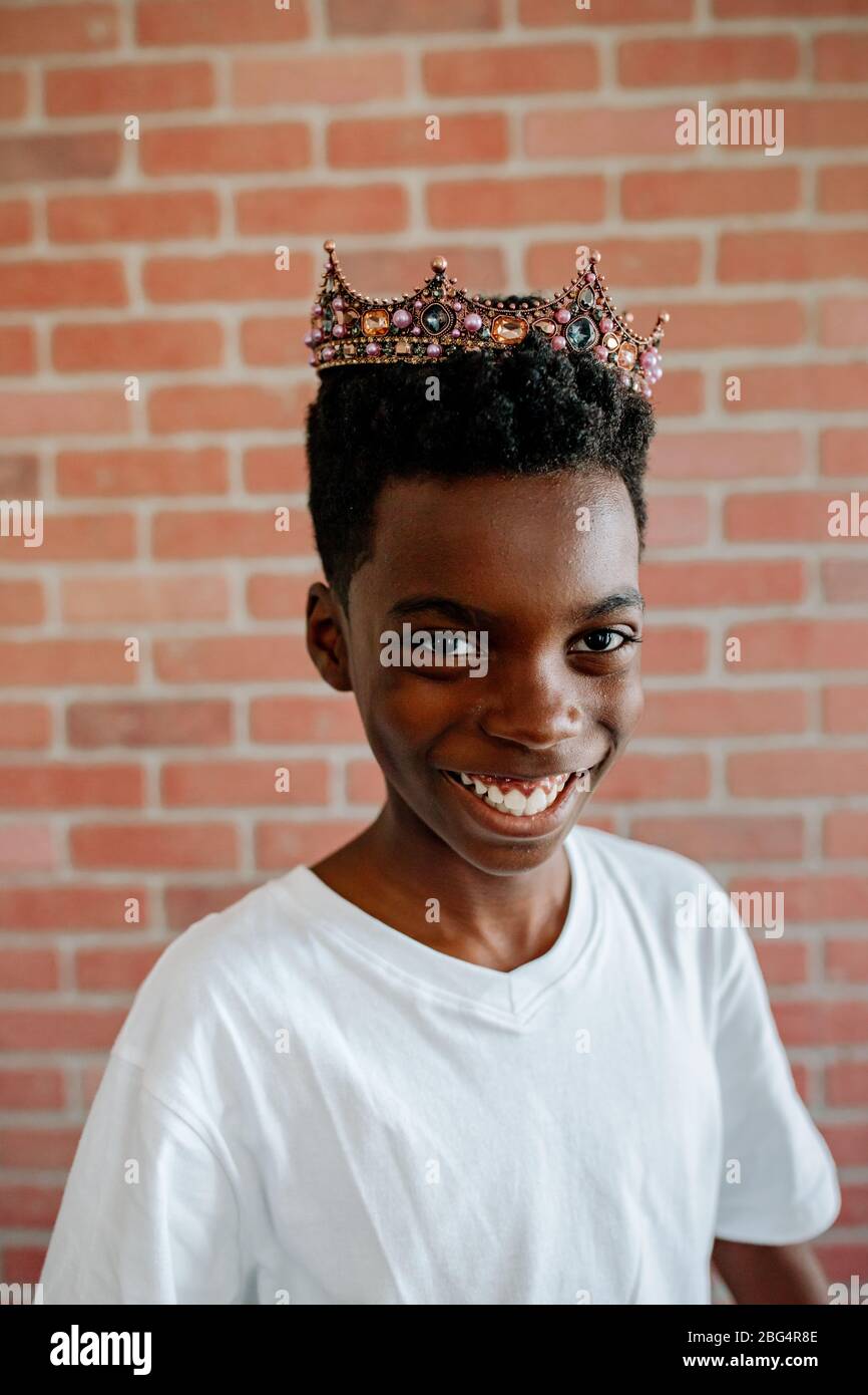 Silly preteen African-American boy wearing jeweled tiara Stock Photo ...