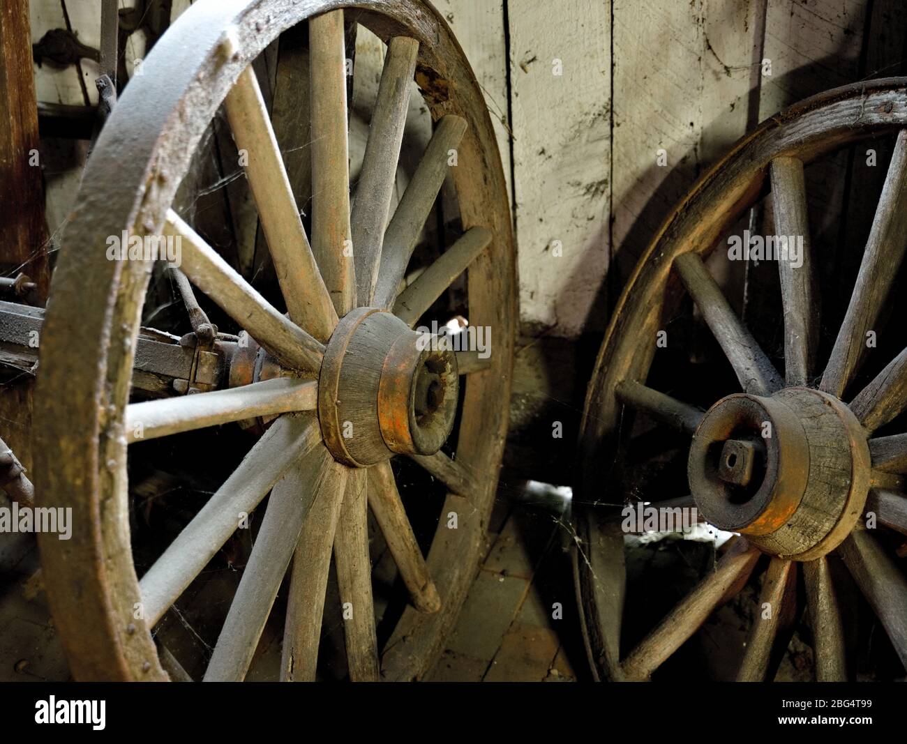 Old, weathered wooden wagon wheels stored in a barn Stock Photo - Alamy