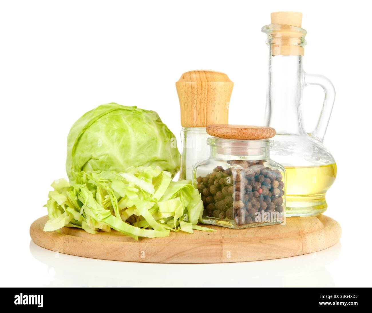 Green cabbage, oil, spices on cutting board, isolated on white Stock ...