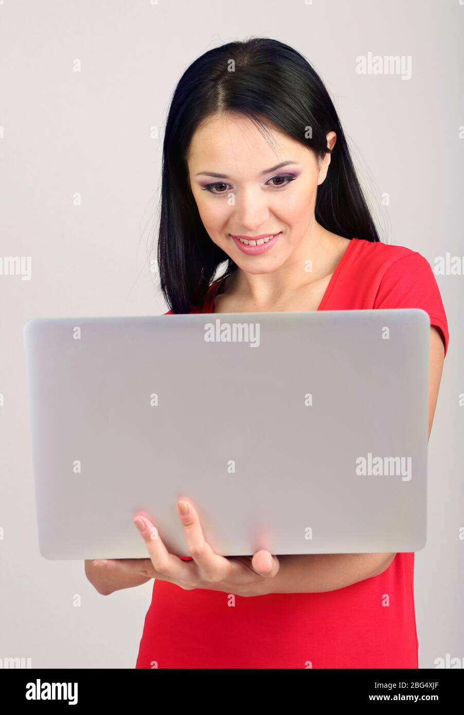 Beautiful young woman with notebook in room Stock Photo - Alamy