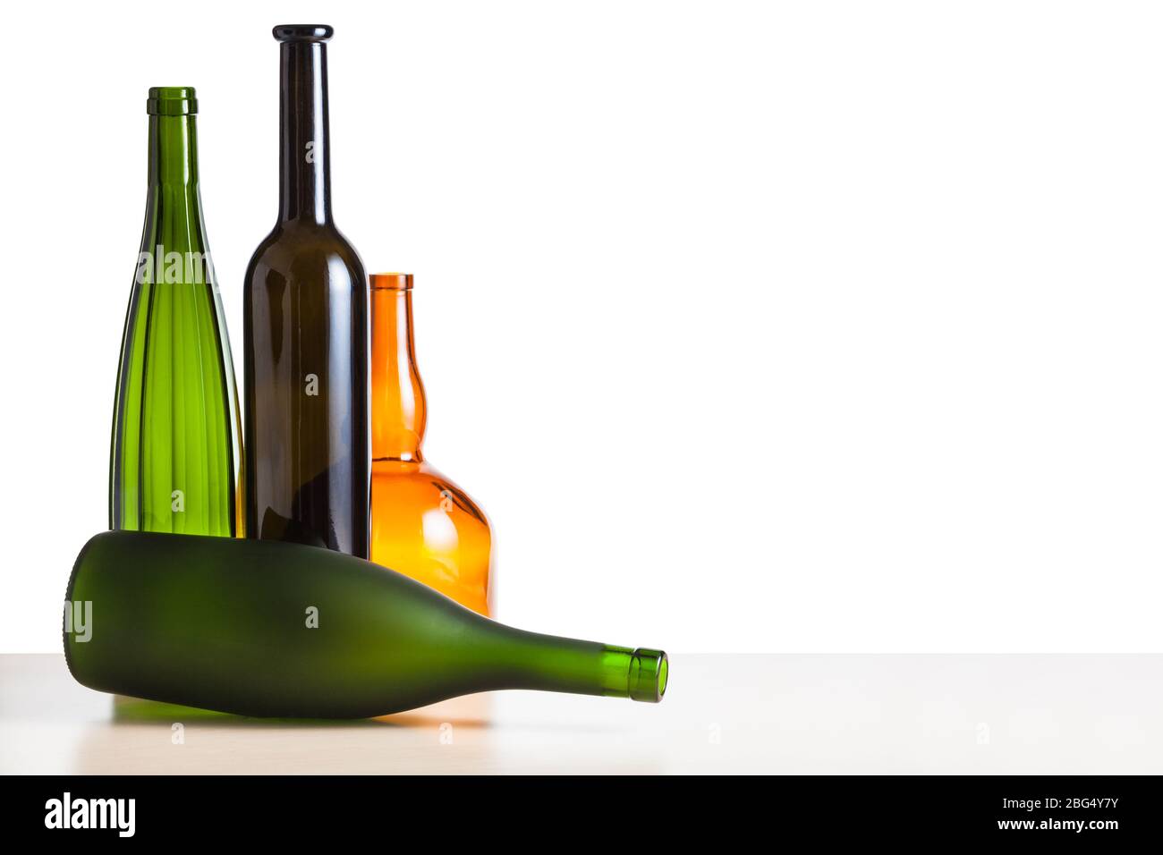 four various empty bottles on wooden table with cutout background Stock ...