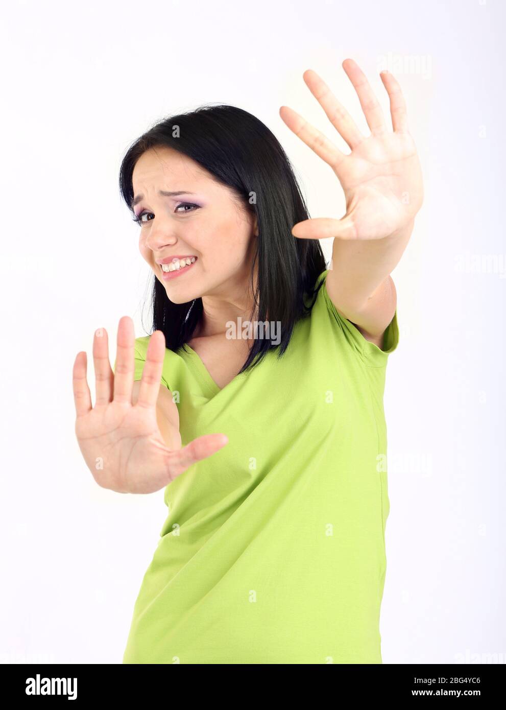 Girl showing stop sign isolated on white Stock Photo - Alamy