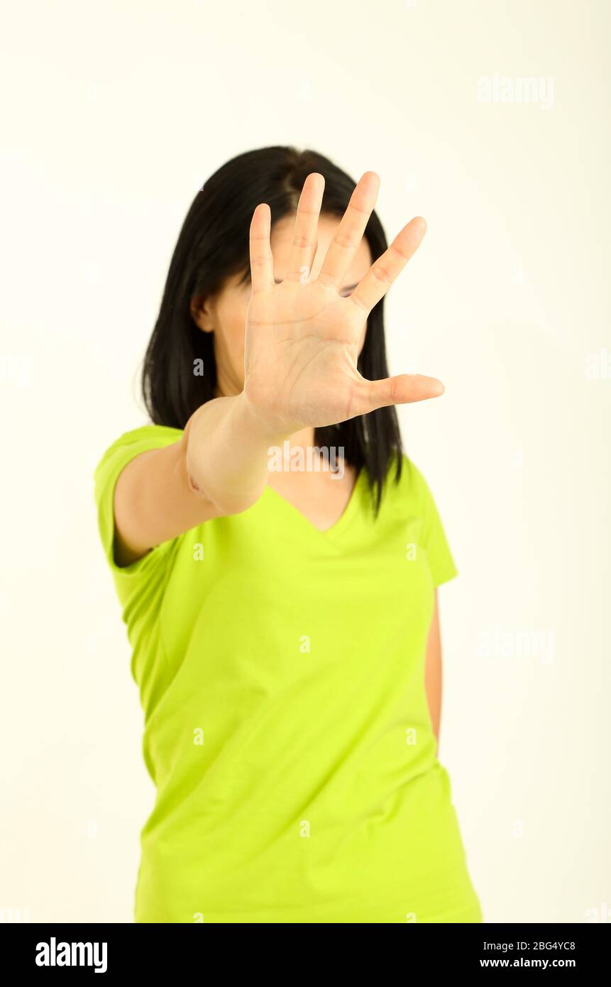 Girl showing stop sign isolated on white Stock Photo - Alamy