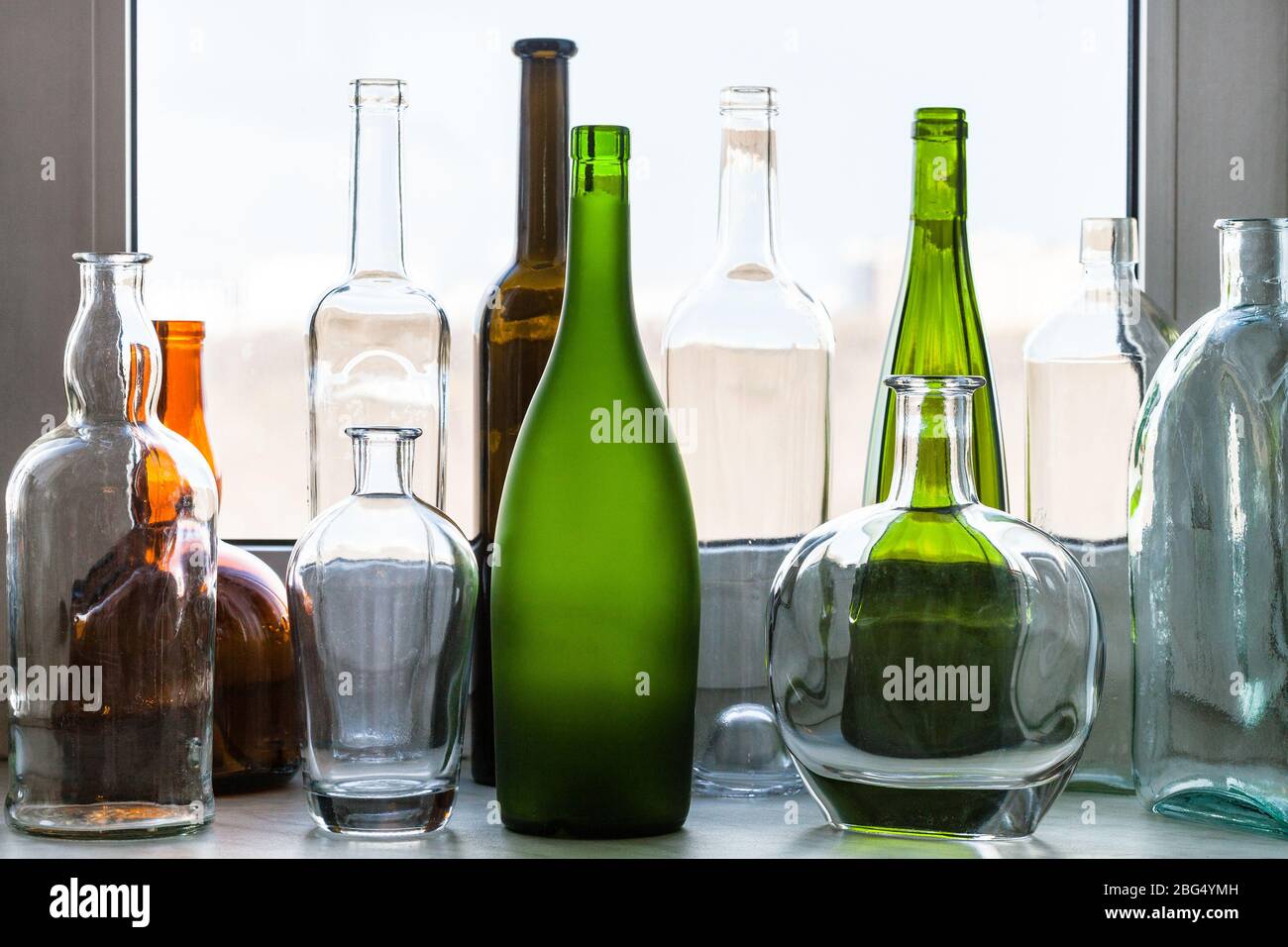 various empty bottles on windowsill at home on sunny spring day Stock ...