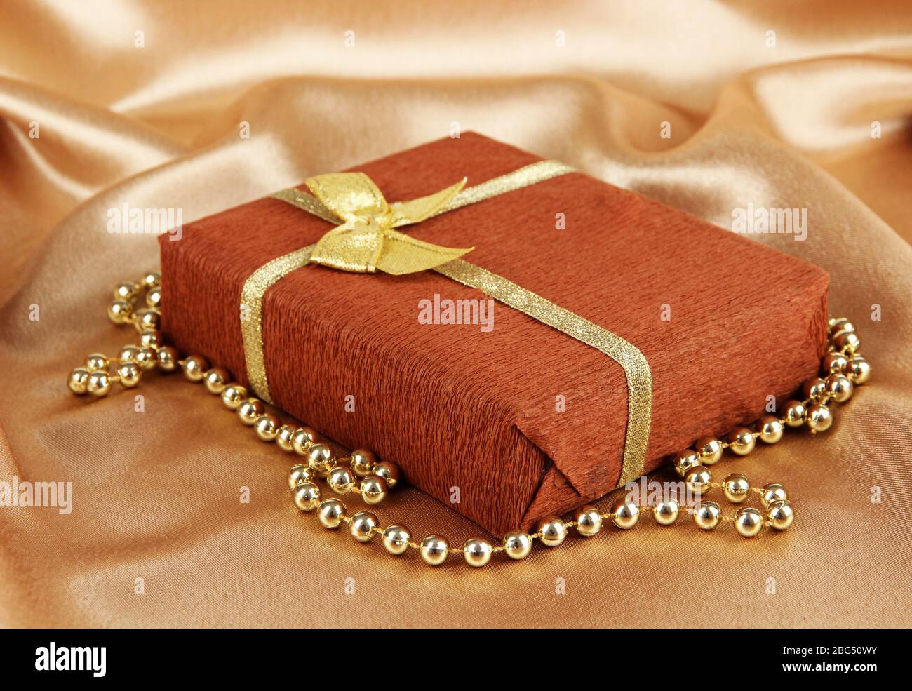 Romantic parcel on gold cloth background Stock Photo - Alamy