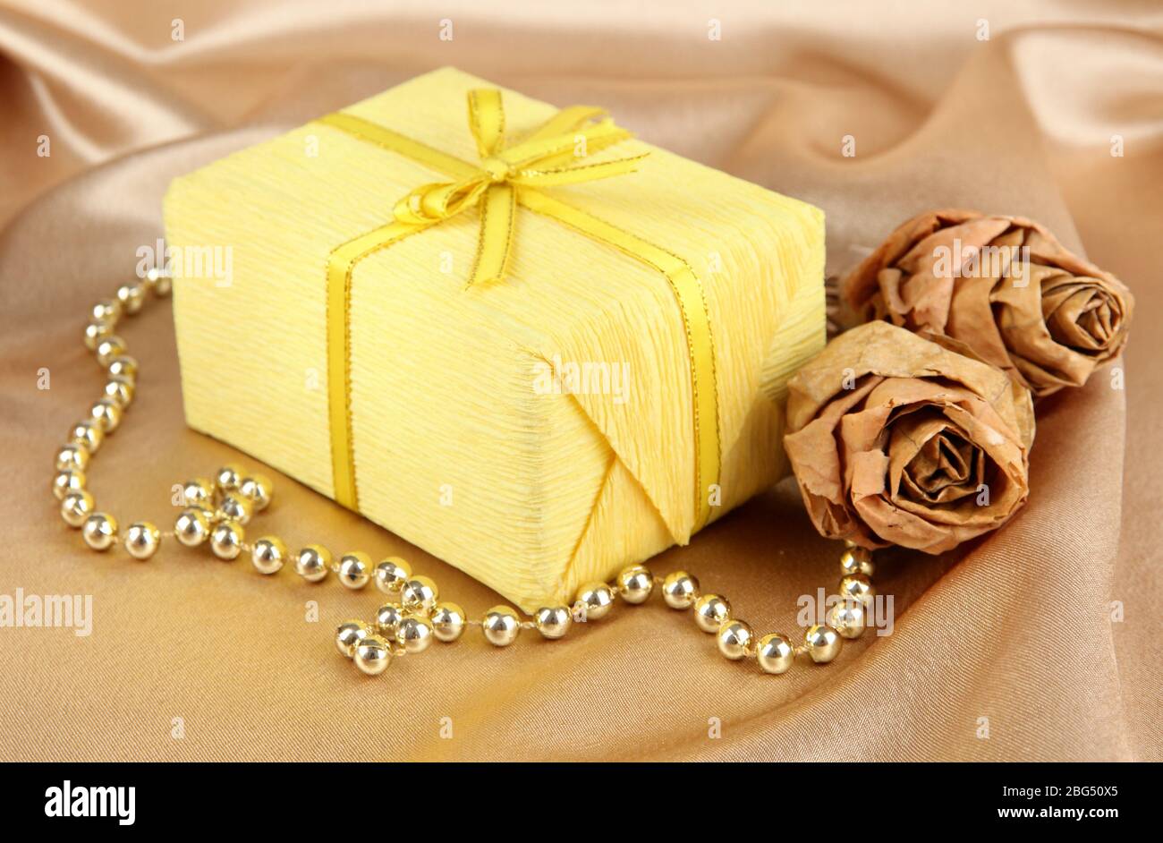 Romantic parcel on gold cloth background Stock Photo - Alamy