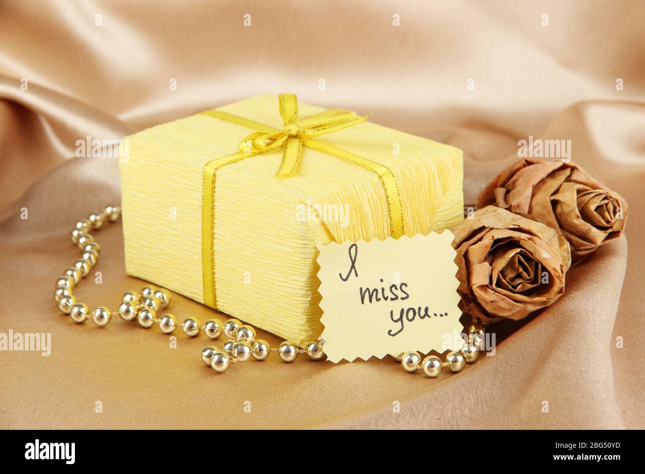Romantic parcel on gold cloth background Stock Photo - Alamy