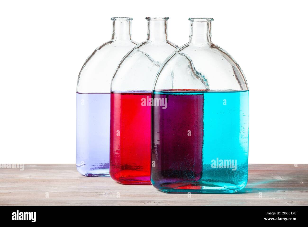 glass flasks with color ink solutions on wooden board with cutout ...