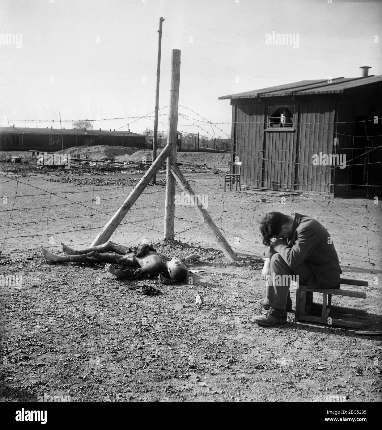 Second World War documentary. A young man sits on an overturned stool ...