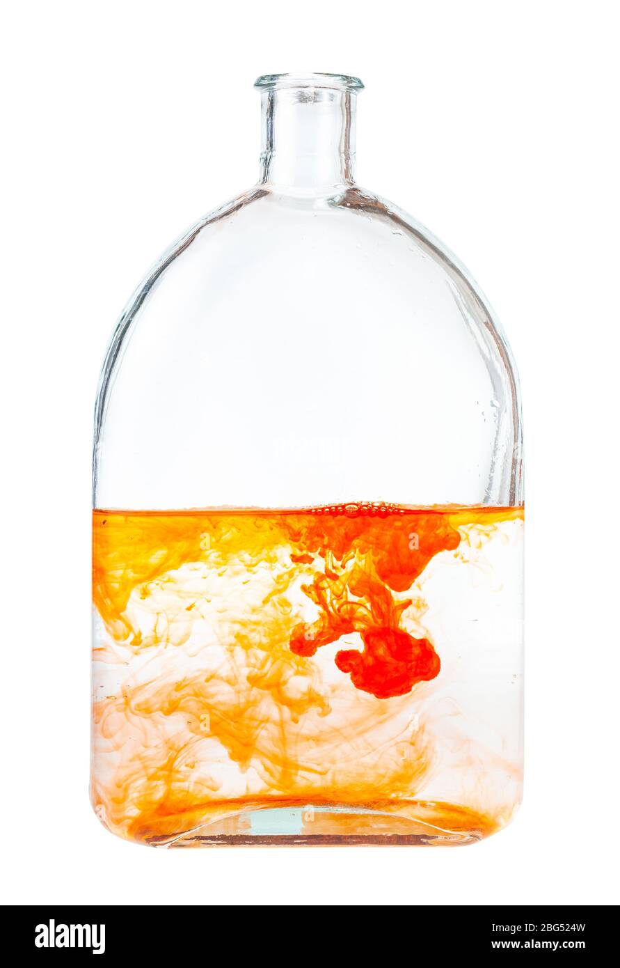 orange watercolors dissolving in water in glass flask isolated on white ...