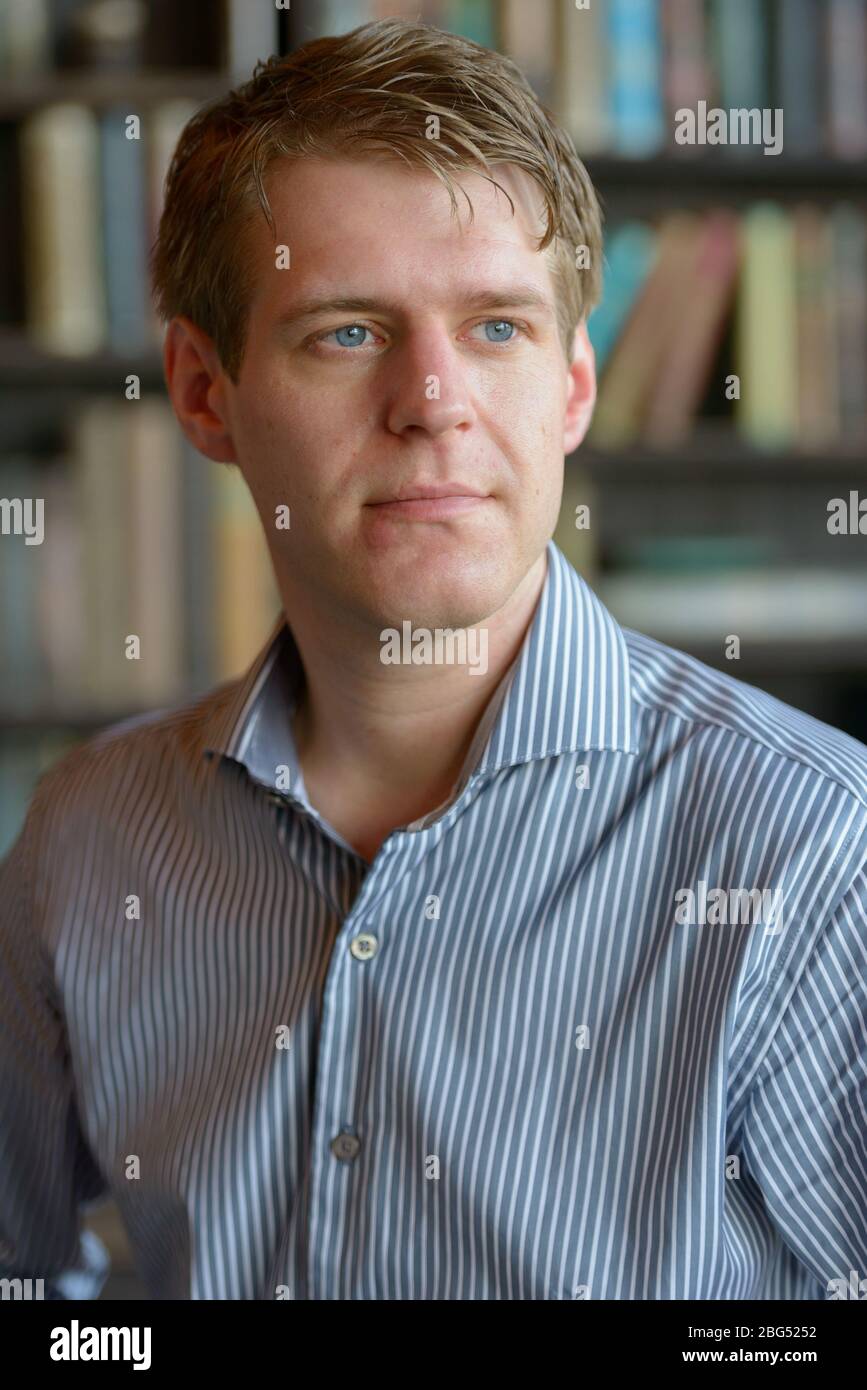 Man thinking in library or reading room Stock Photo - Alamy